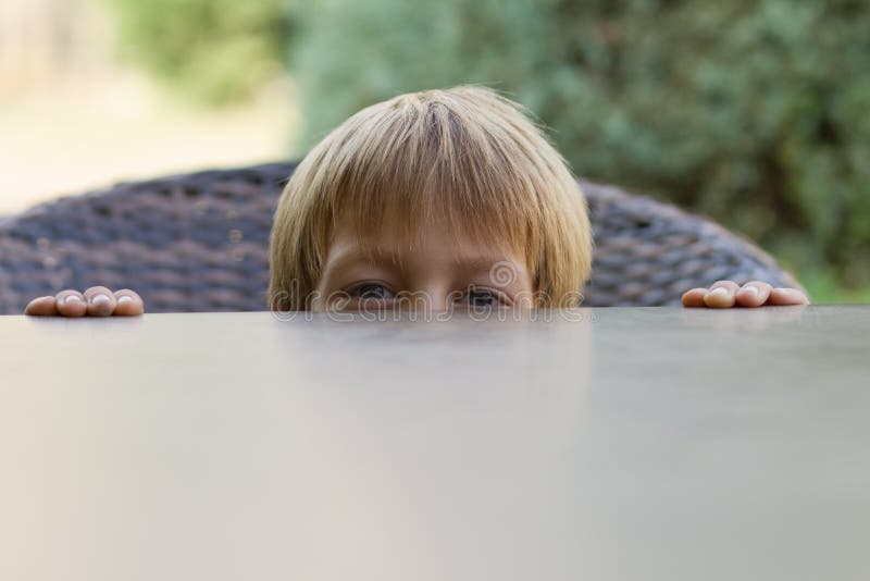 Little Boy Hiding Behind the Table Stock Photo - Image of pretty, small ...