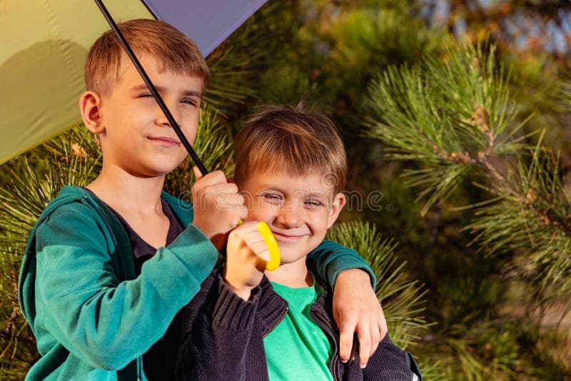 The Little Boy and His Elder Brother are Under a Bright Multi-colored ...
