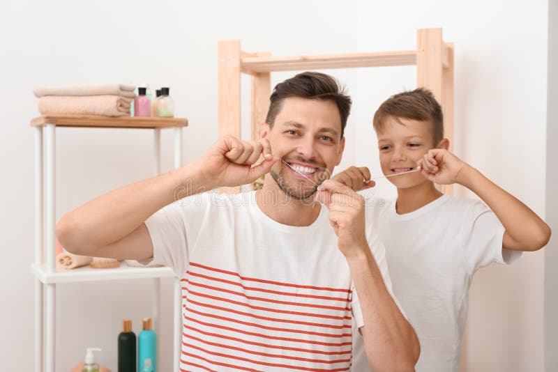 Little Boy and His Father Flossing Teeth in Bathroom Stock Image ...