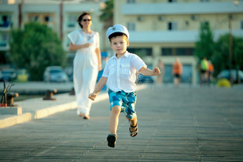 Little Boy and His Mother Running at Jetty Stock Image - Image of dress ...