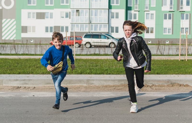 A Little Boy and His Older Sister Run Across the Road Stock Image ...