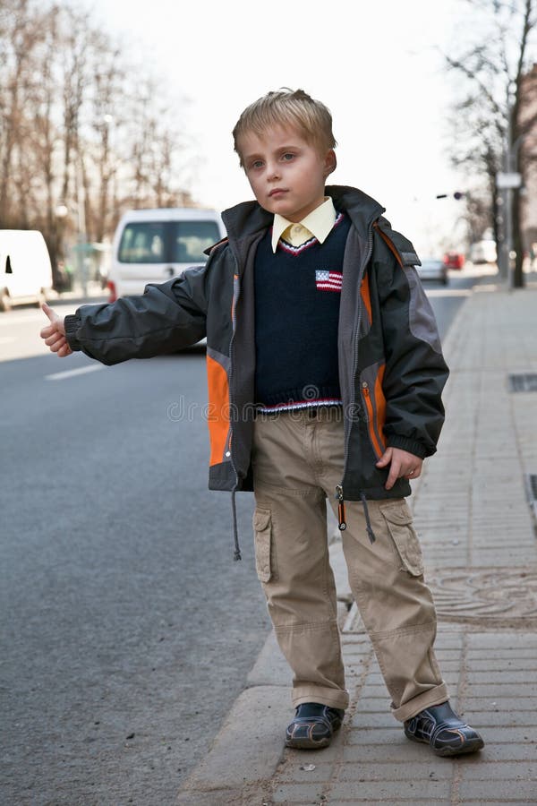 Little Boy Hitchhiking on the Road Stock Image - Image of traveller ...