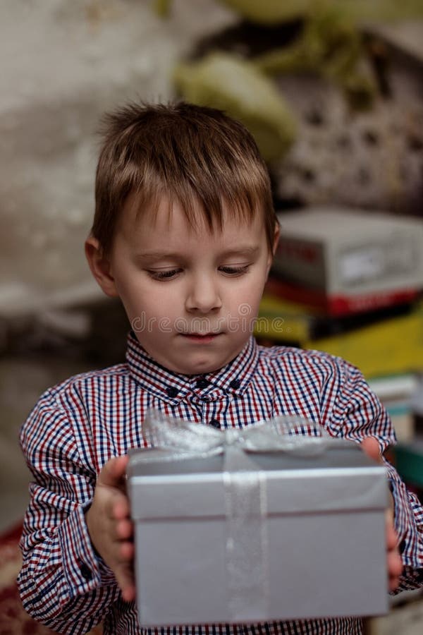 A Little Boy is Holding a Box with a Gift Stock Image - Image of party ...