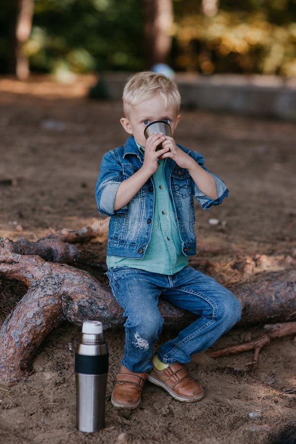 Little Boy Holding a Cup of Tea Outdoors. Child Drinks Tea Stock Image ...