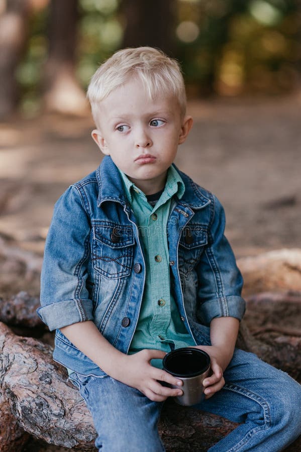 Little Boy Holding a Cup of Tea Outdoors. Child Drinks Tea Stock Photo ...