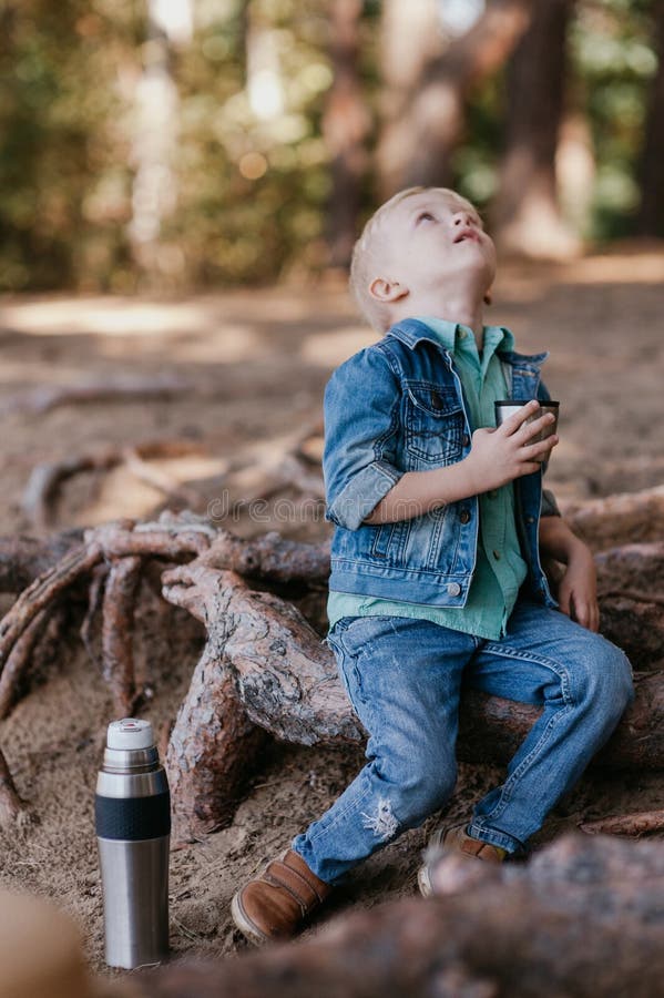 Little Boy Holding a Cup of Tea Outdoors. Child Drinks Tea Stock Photo ...