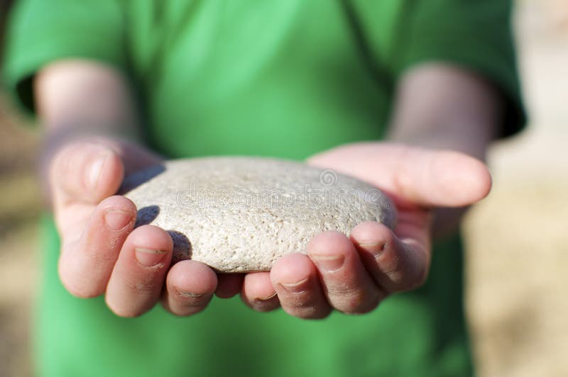 Little Boy Holding Stone stock photo. Image of horizontal - 18915358