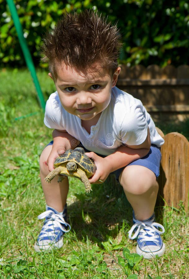 Boy holding turtle shell stock image. Image of outside - 37888545