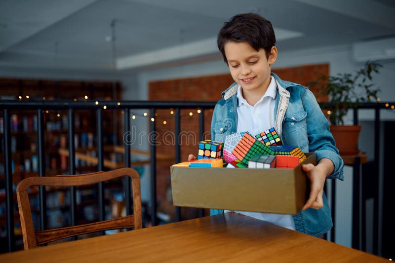 Little Boy Holds Box of Different Puzzle Cubes Editorial Image - Image ...
