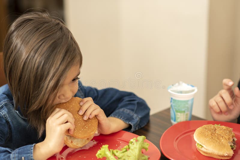 Little Boy Indoors Eating a Burger Stock Image - Image of hungry ...