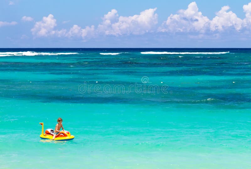 Little Boy on an Inflatable Boat on Tropical Beach Stock Image - Image ...