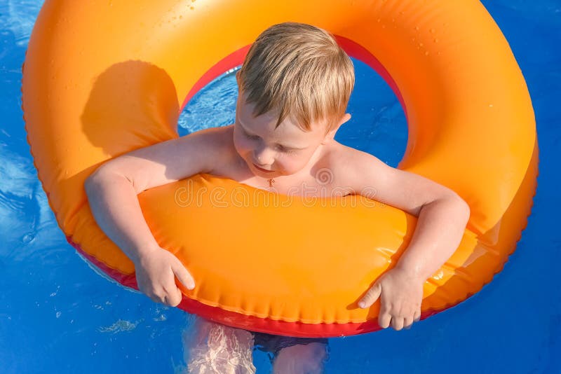 Little Boy on an Inflatable Circle in the Water Stock Image - Image of ...