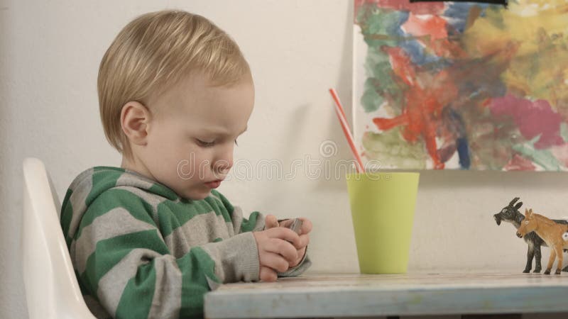 A Little Boy is Interested in Playing on the Phone. Stock Footage ...