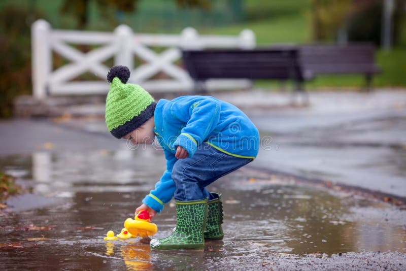 Little Boy, Jumping in Muddy Puddles Stock Photo - Image of toddler ...