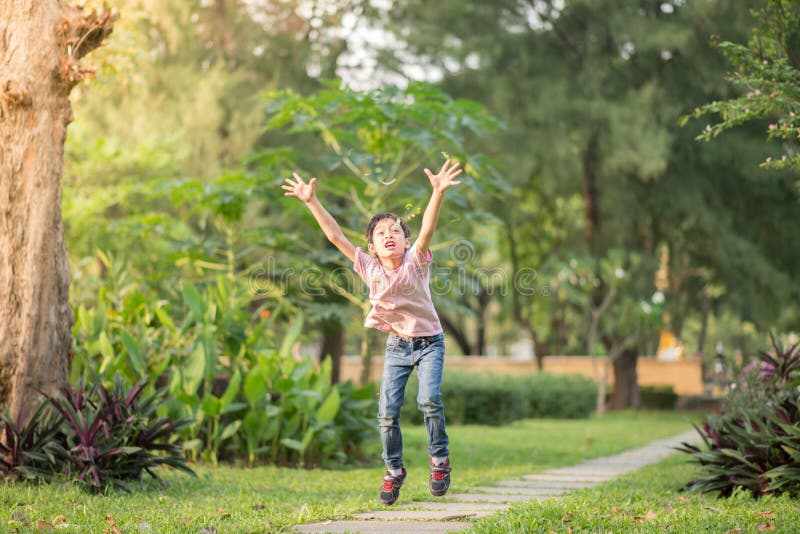 Little Boy Jumping and Running in the Park Outdoor Stock Photo - Image ...