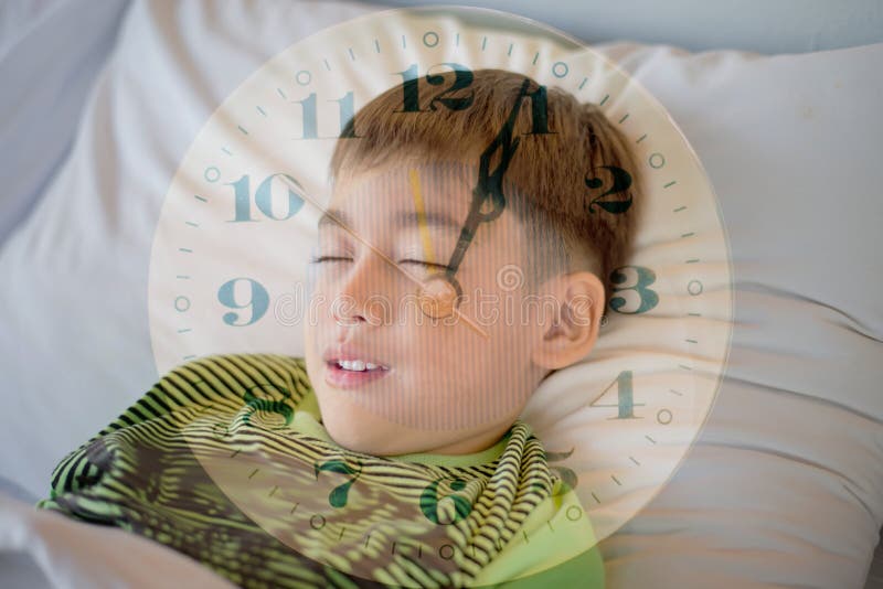Little Boy Laying Down on the Bed with Clock Exporsure Stock Image ...