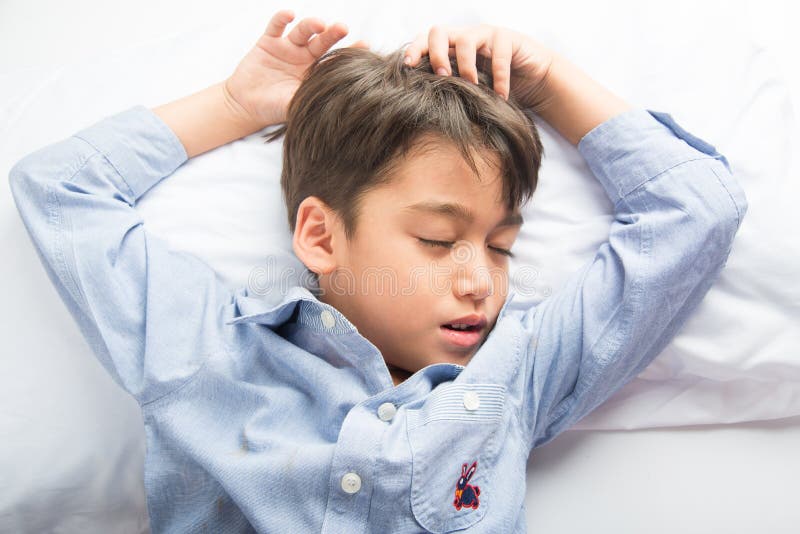 Little Boy Laying Down on the Bed Cute Beautiful Face Stock Photo ...