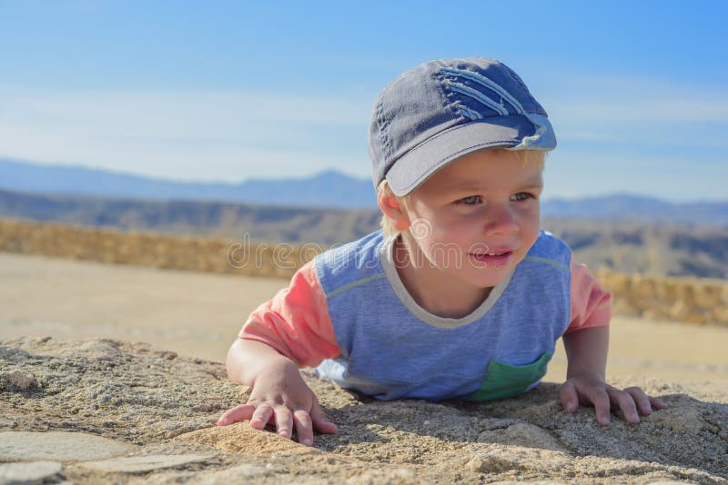 Little Boy Laying Down on the Rock Stock Image - Image of playing ...