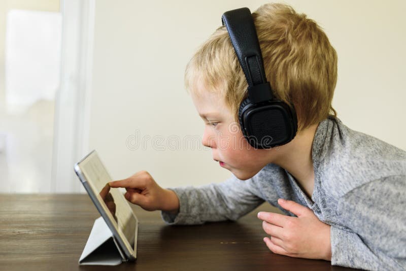 Little Boy Learning at Home. Watching Webinar on Mobile Tablet Stock ...