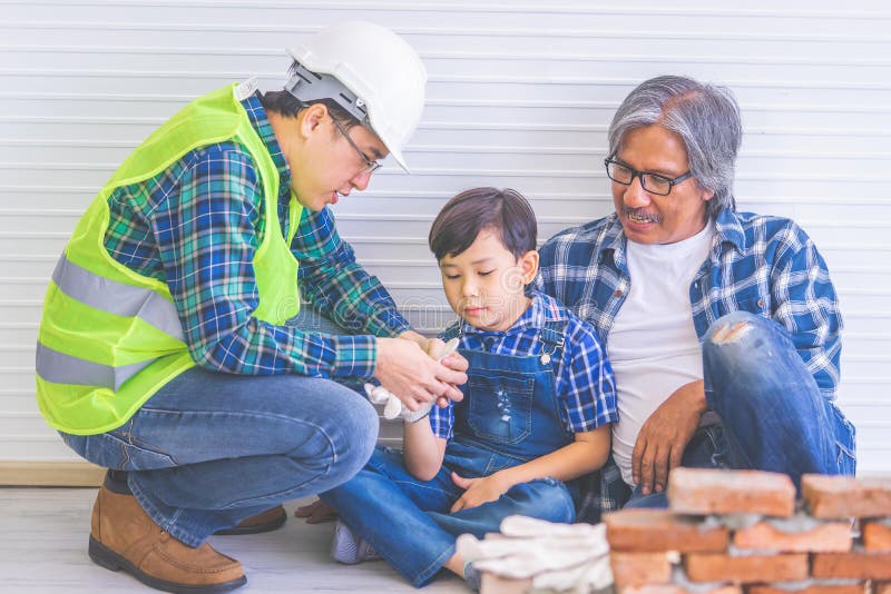 Little Boy Learning How To Build Brick Wall from His Construction Multi ...