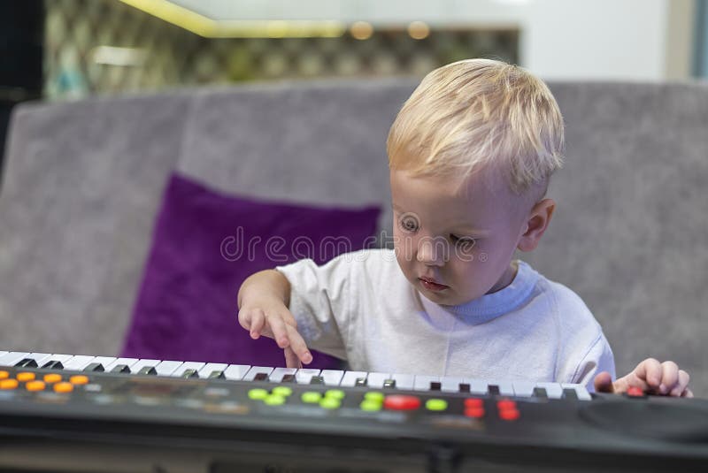 Little Boy Learning To Play the Piano at Home Stock Photo - Image of ...