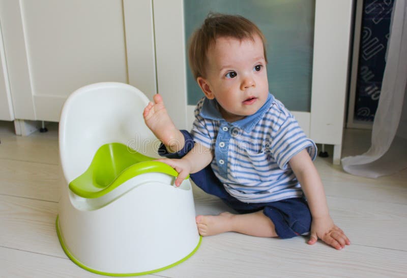 A Little Boy Learns To Go Potty. Accustom the Child To the Potty Stock ...