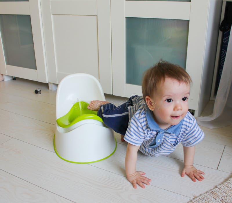 A Little Boy Learns To Go Potty. Accustom the Child To the Potty Stock ...