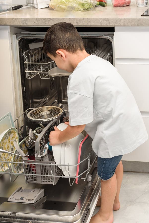 Son Helping Father with the Dishwasher. Chores Concept. Stock Photo ...