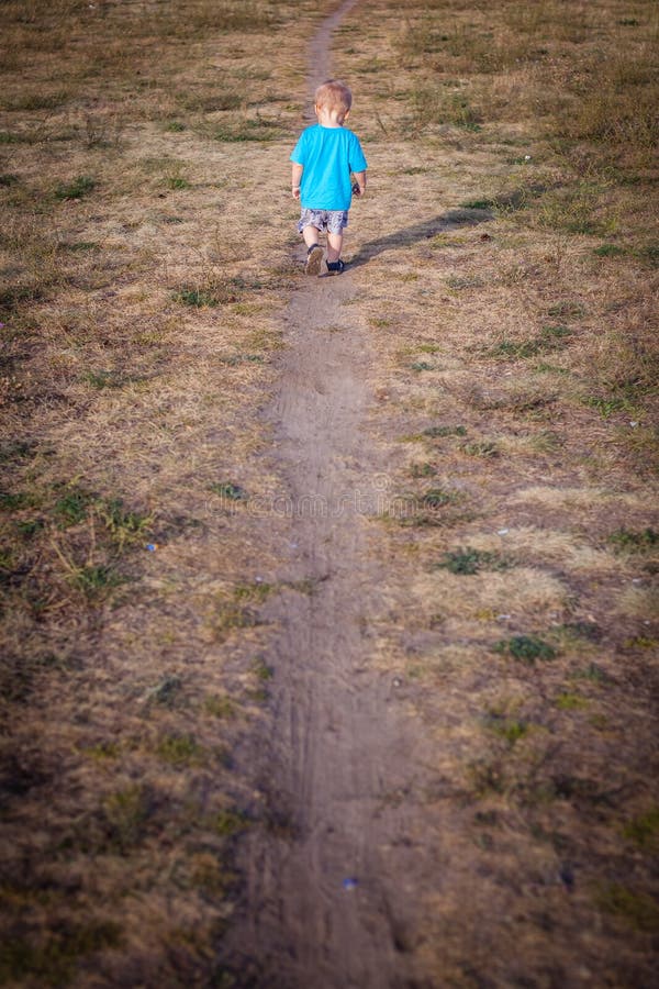 Little Boy on a Lonely Walk Stock Photo - Image of narrow, happy: 64357282