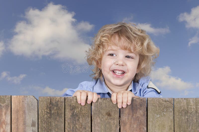 Little Boy Looking from Above a Fence, Stock Image - Image of curly ...