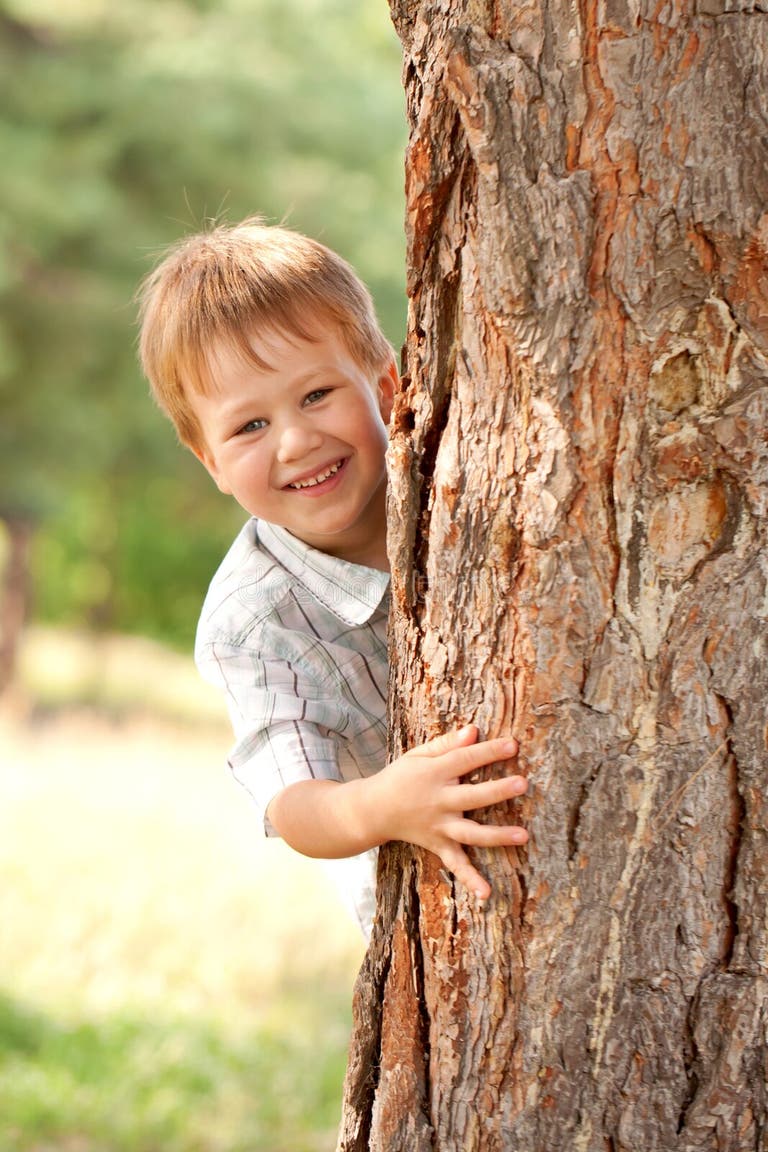 Little Boy Looking Out Behind Tree Stock Photos - Free & Royalty-Free ...