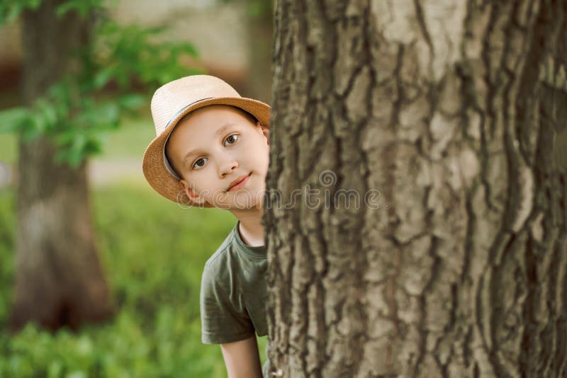 Little Boy Looking Out from Behind a Tree. Summer Activity Stock Photo ...