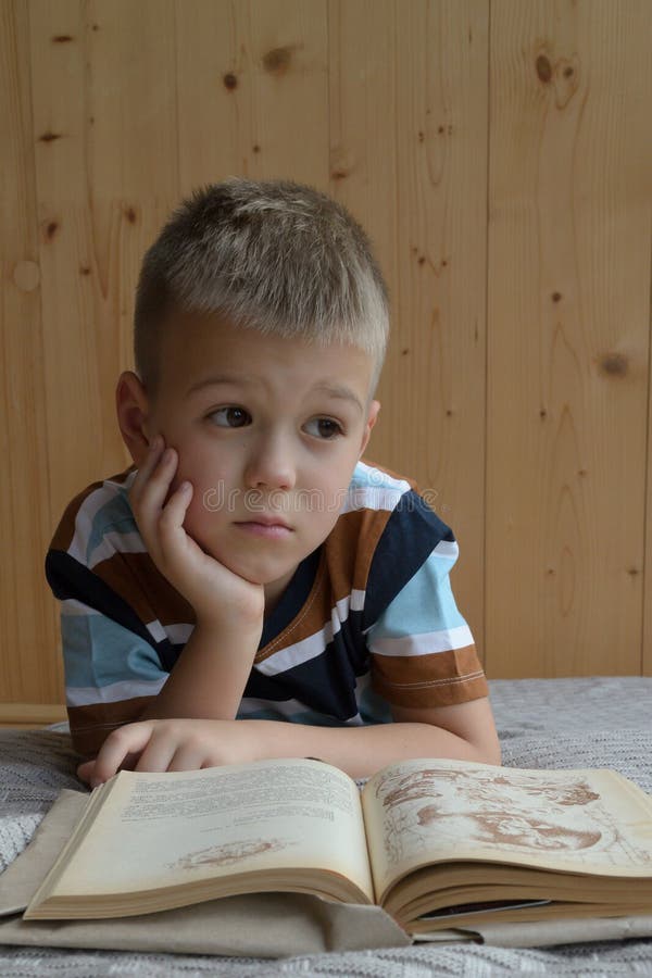 A Little Boy Looks Thoughtfully into the Distance Stock Photo - Image ...