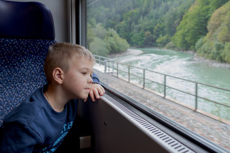 Little Boy Looks Thoughtfully Out the Train Window Stock Photo - Image ...