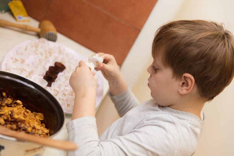 Little boy making cookies stock photo. Image of serious - 245437346