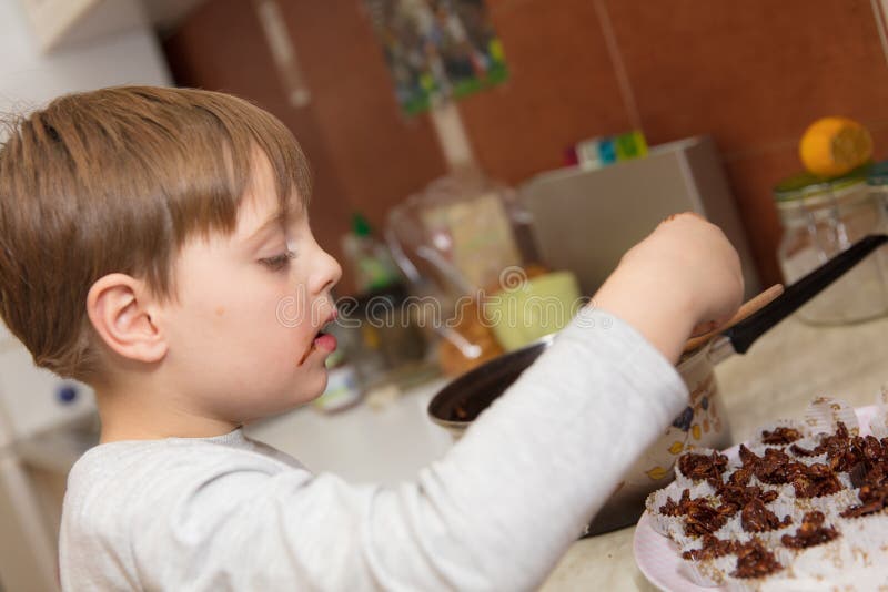 Little boy making cookies stock image. Image of eating - 245437495