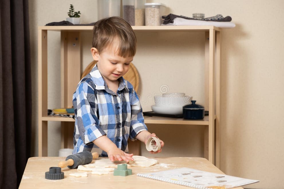 Little Boy Making Cookies Using Cookie Cutters and Dough in the Kitchen ...