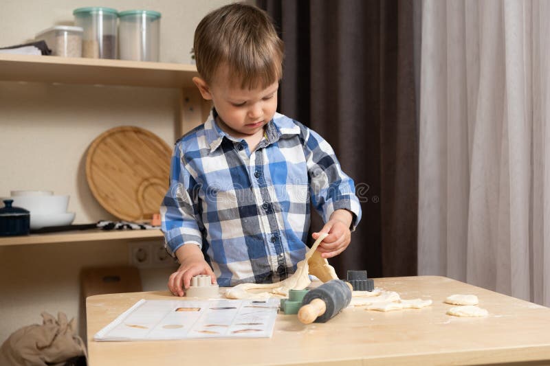 Little Boy Making Cookies Using Cookie Cutters and Dough in the Kitchen ...