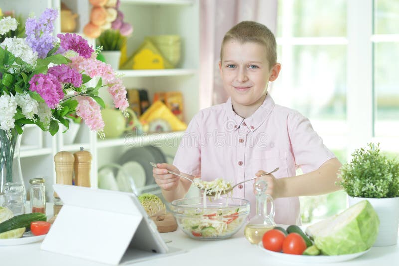 Little Boy Making Dinner on Kitchen Table with Tablet at Home Stock ...