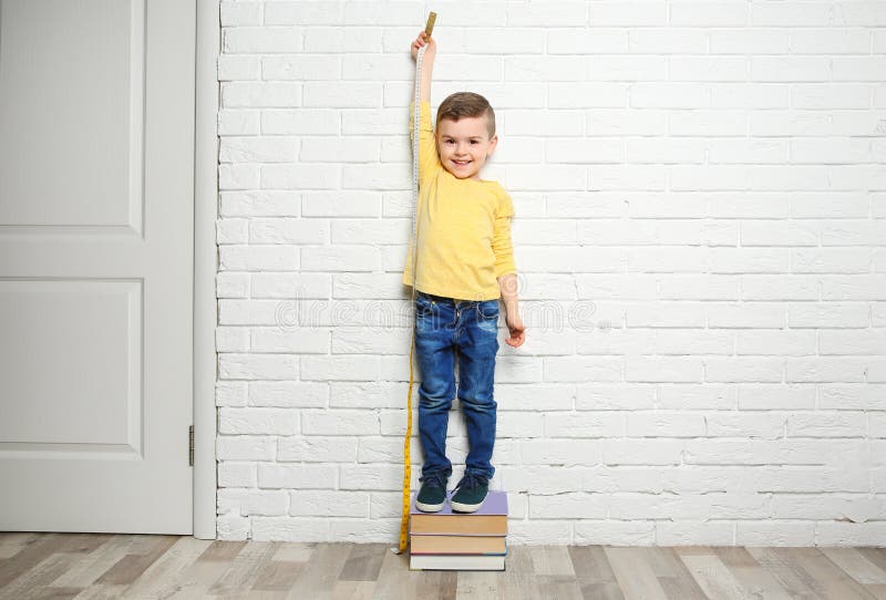 Little Boy Measuring His Height Near Wall Stock Image - Image of ...