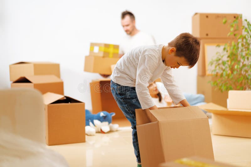 Little Boy Packing a Moving Box for a New Home Stock Image - Image of ...