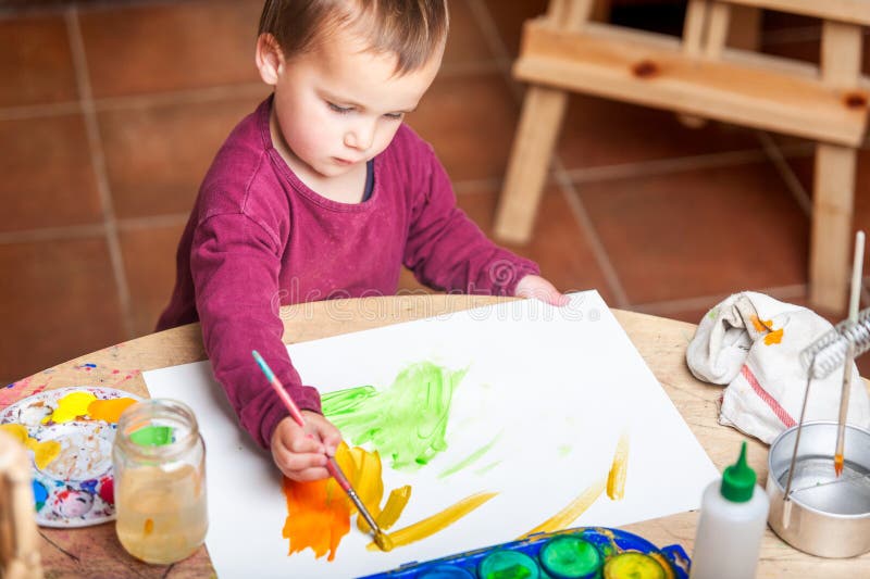 Little Boy Painting His White Canvas with Acrylic Paints Stock Image ...