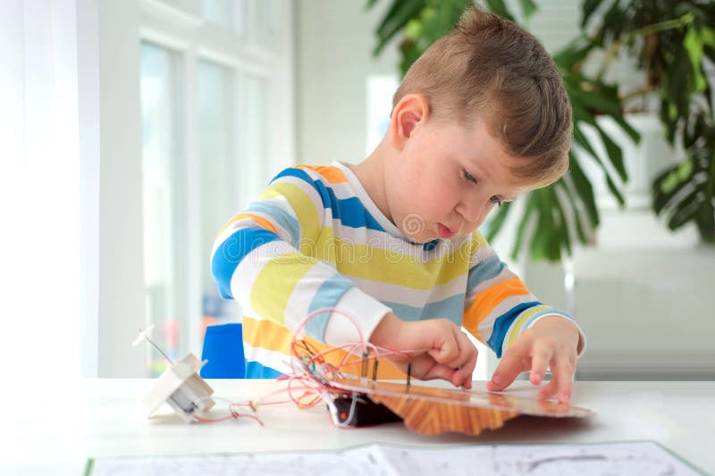 Little Boy Performing or Studying Science with Wires, Connections ... Little Boy Performing or Studying Science with Wires, Connections ...