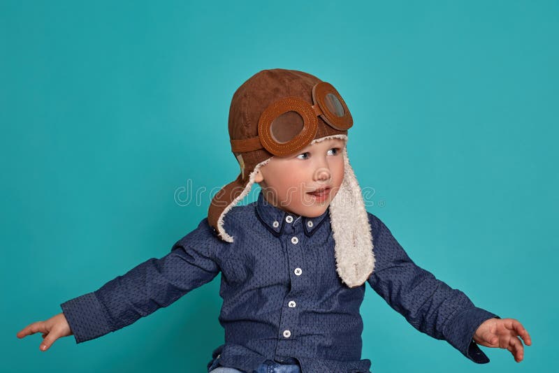 A Little Boy in a Pilot Suit Plays and Dreams of Flying Above the ...