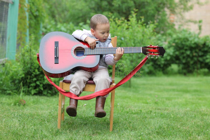 209 Little Boy Play Guitar Outdoors Stock Photos - Free & Royalty-Free ...