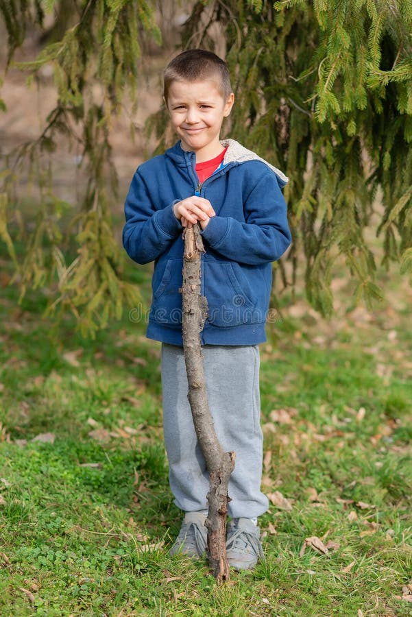 Little Boy Play with Stick in Forest Stock Image - Image of leaf, alley ...