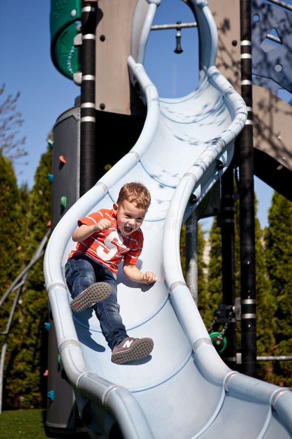 Little Boy on the Playground Slide Stock Image - Image of slide, park ...