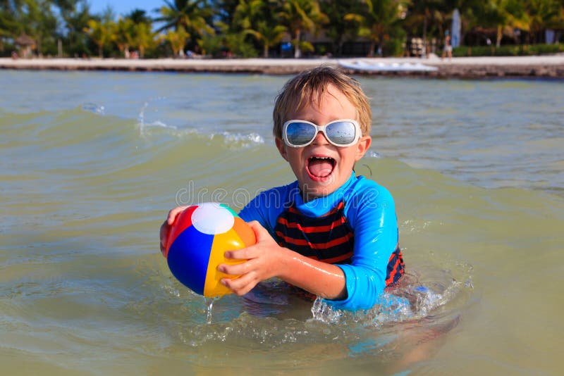 Little Boy Playing Ball on Beach Stock Photo - Image of lifestyles ...