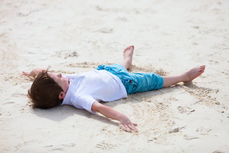 Boy Beach Making Sand Angel Stock Photos - Free & Royalty-Free Stock ...
