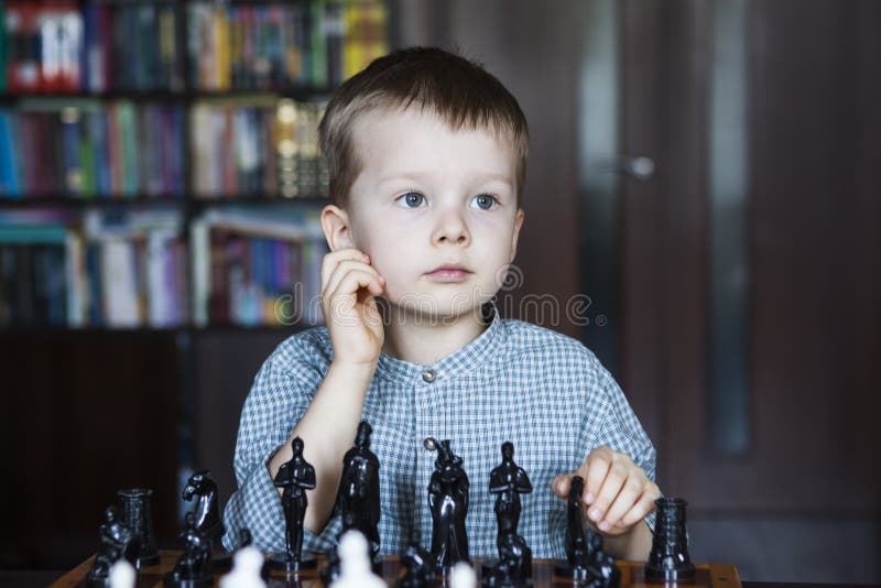 Little boy playing chess. stock photo. Image of plays - 185797398